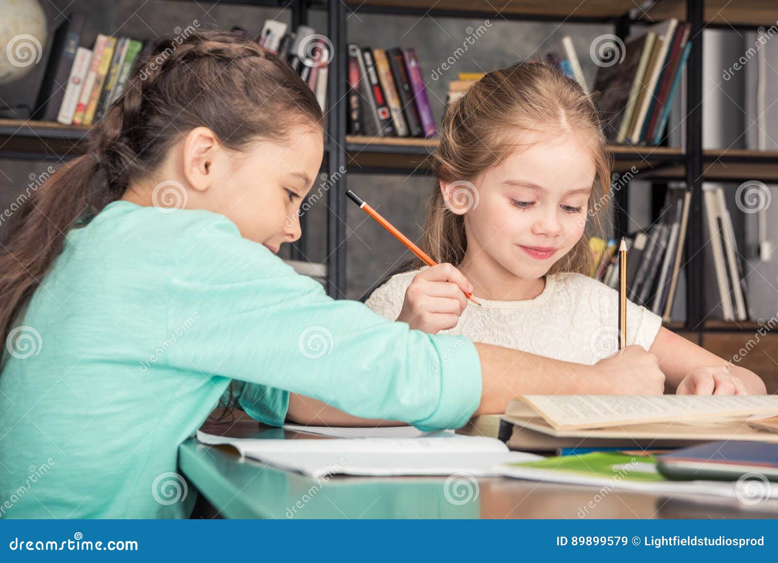 Smiling Classmates Doing Homework Together in Library Stock Image ...