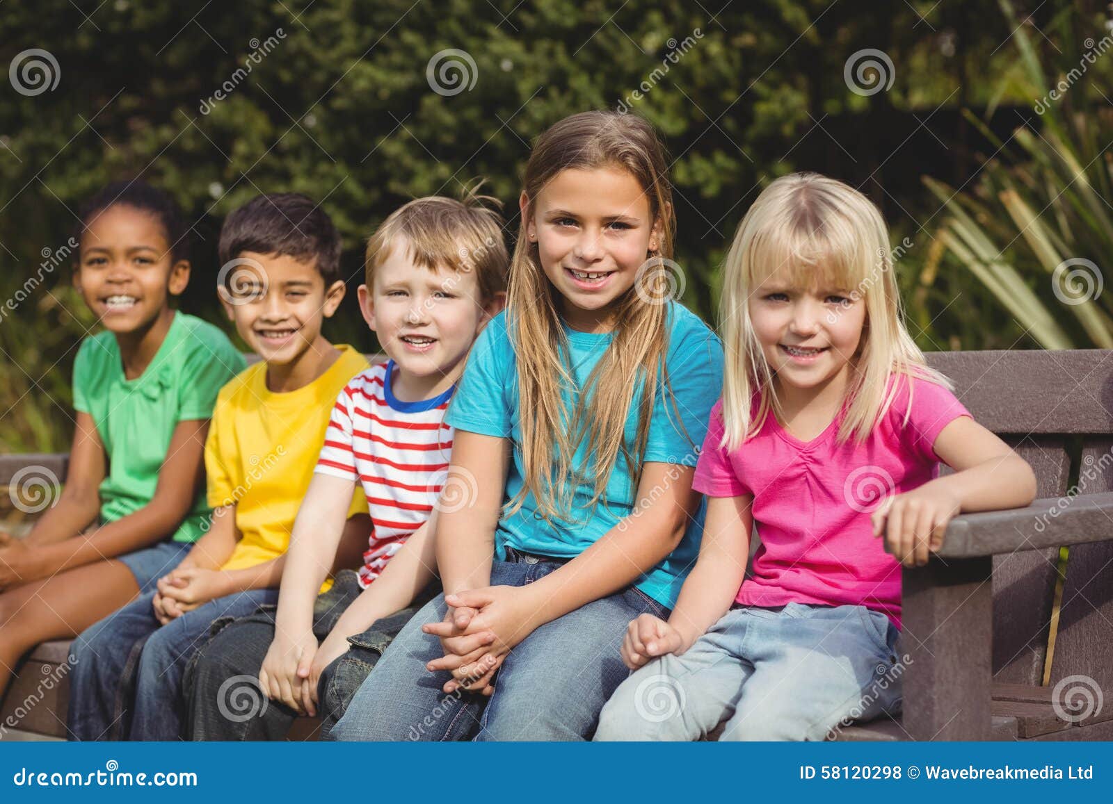 Smiling Classmates Sitting on Bench Stock Photo - Image of schoolchild ...