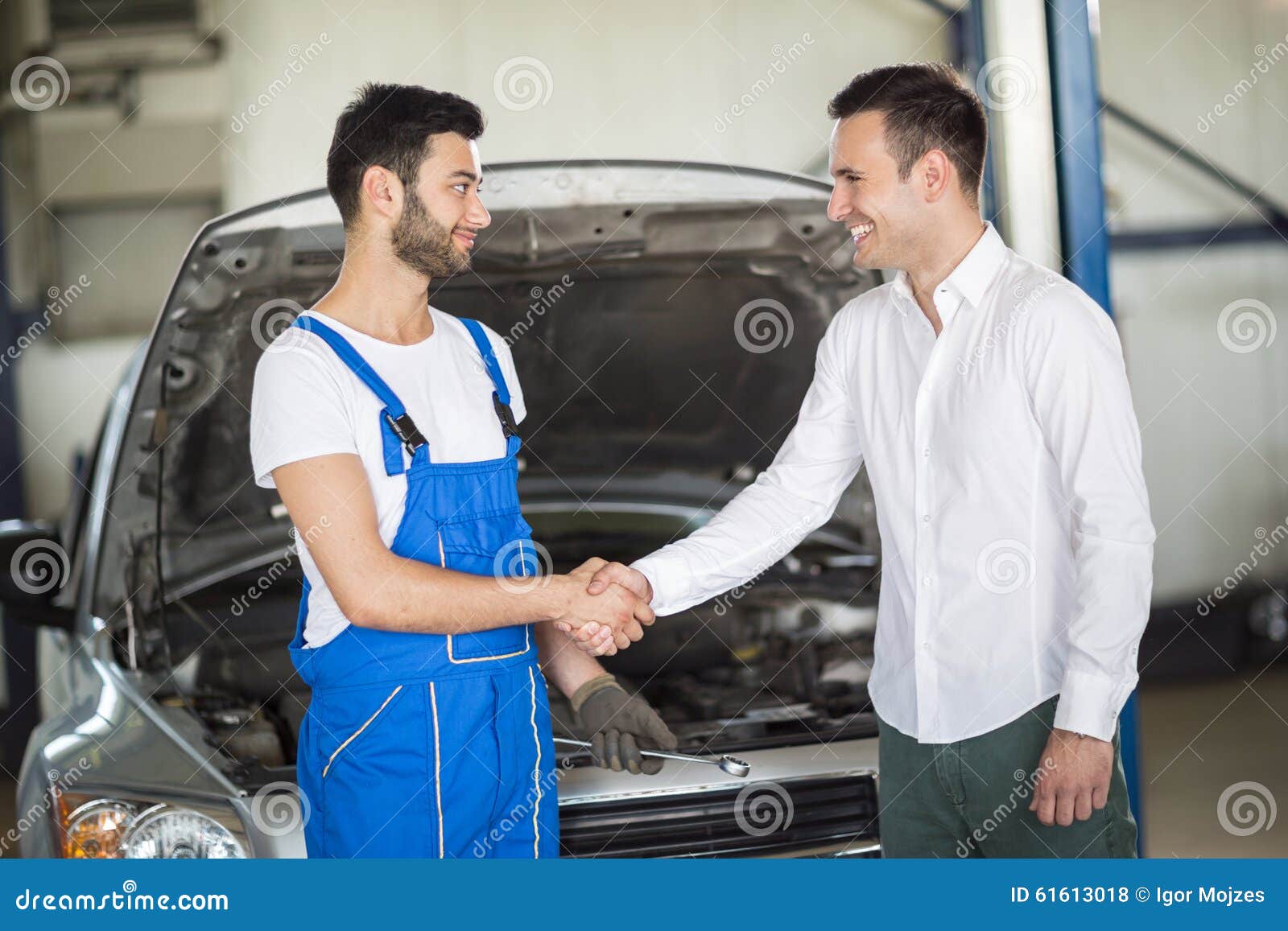 Smiling Client and Mechanic Shaking Hands Stock Photo - Image of ...