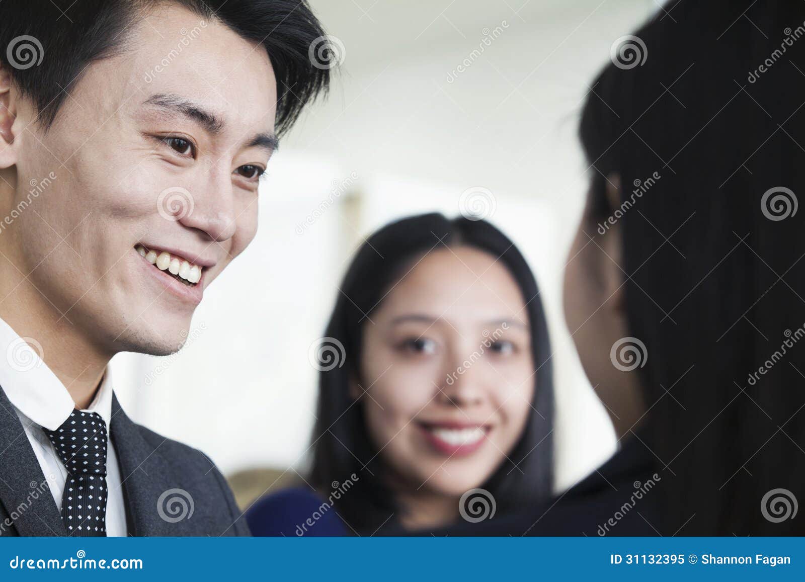 Smiling Co-workers Talking in Office Stock Image - Image of front ...
