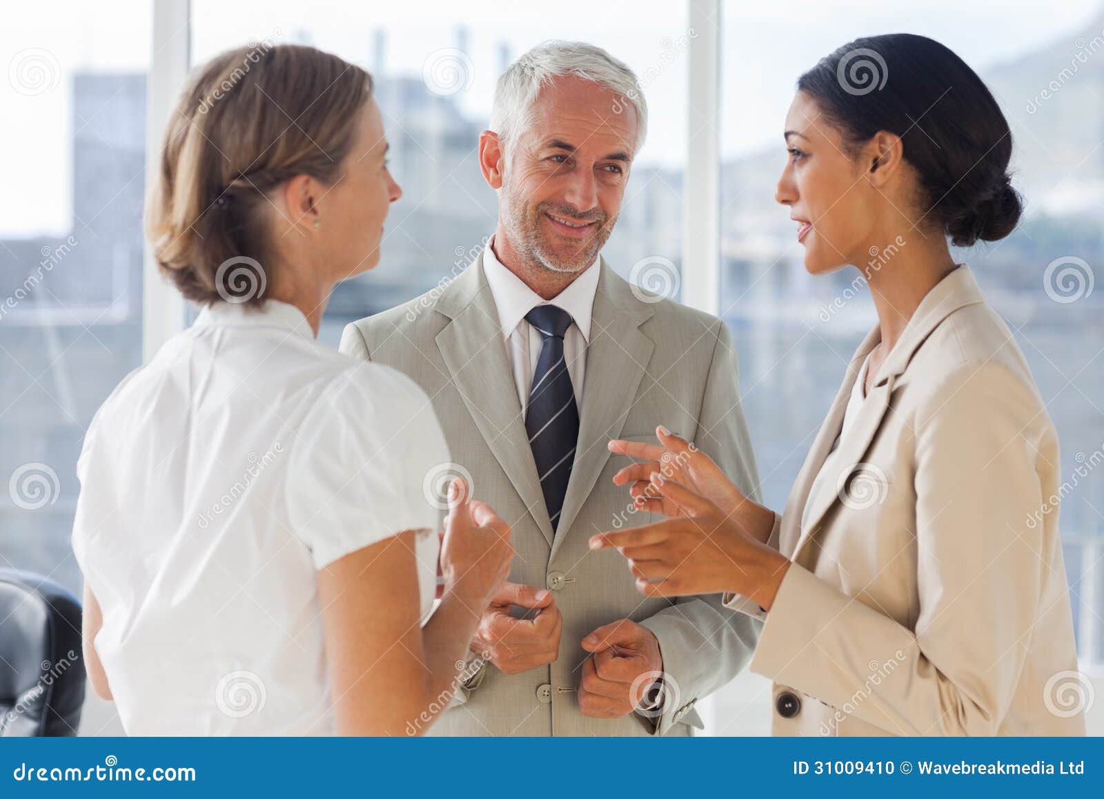 Smiling Colleagues Discussing Together Stock Photo - Image of hair ...