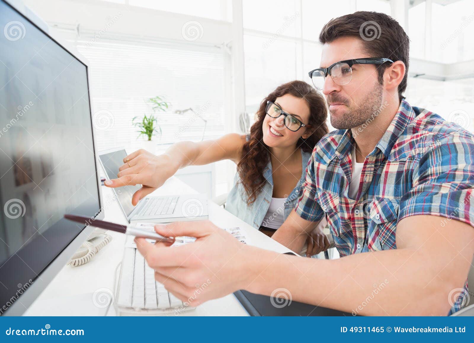 Smiling Colleagues Pointing Computer Together Stock Image - Image of ...