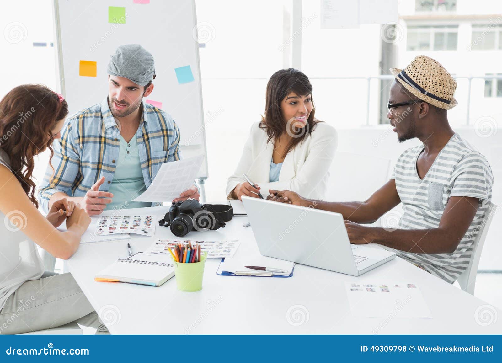 Smiling Colleagues Sitting at Desk Interacting Stock Photo - Image of ...