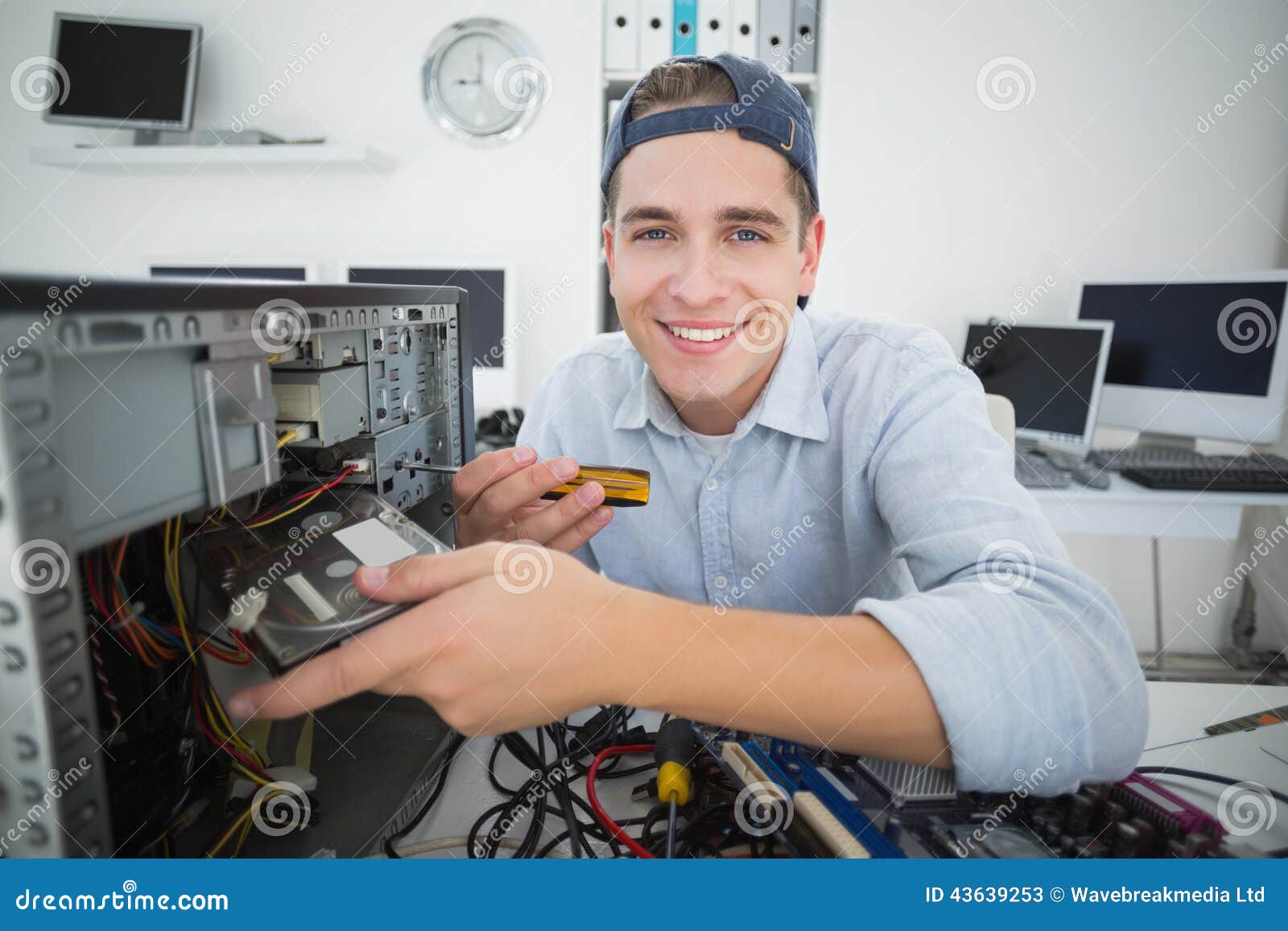 Smiling Computer Engineer Working On Broken Console With Screwdriver ...