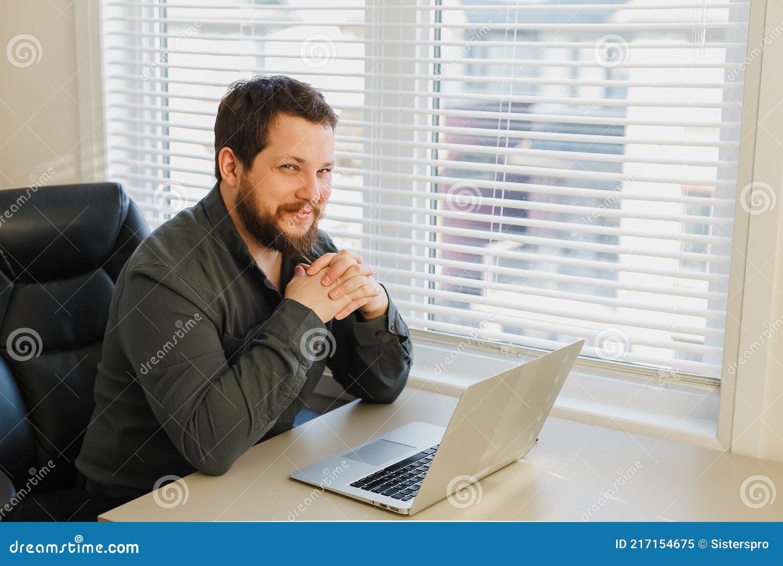 Smiling Computer Hacker Working Online with Laptop at Cabinet. Stock ...