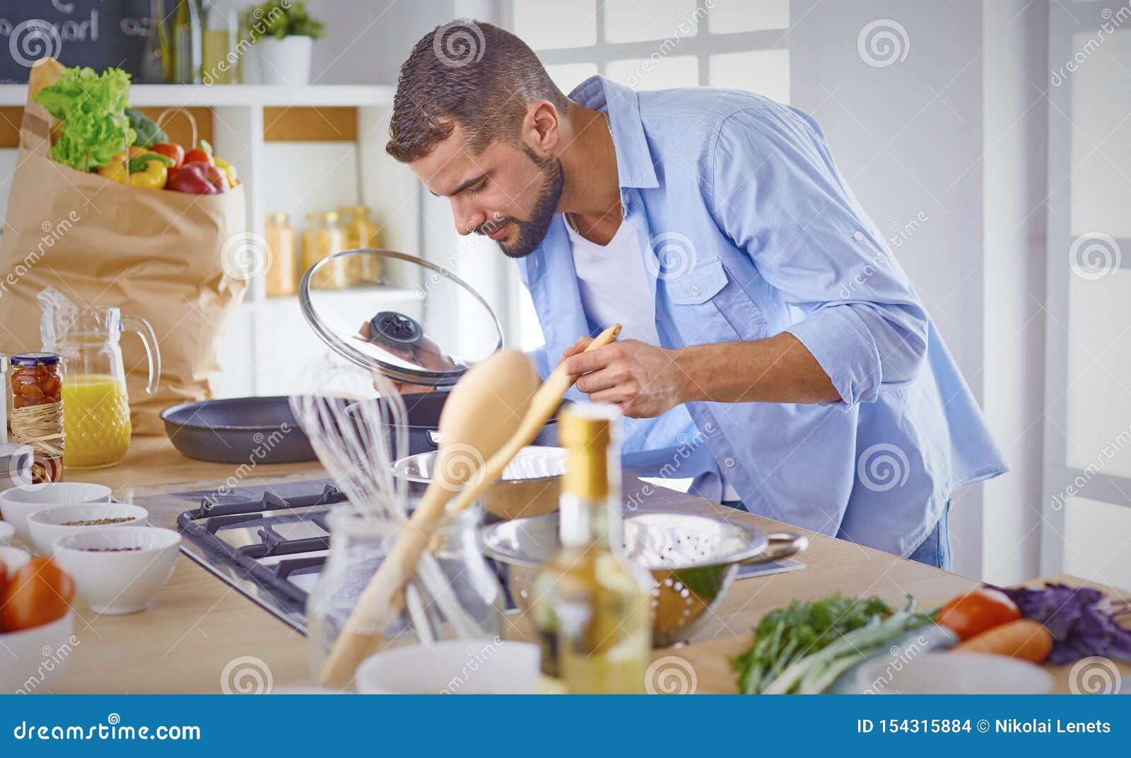 Smiling and Confident Chef Standing in a Large Kitchen Tasting Stock ...