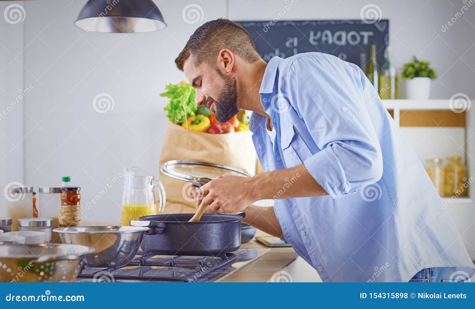 Smiling and Confident Chef Standing in a Large Kitchen Tasting Stock ...
