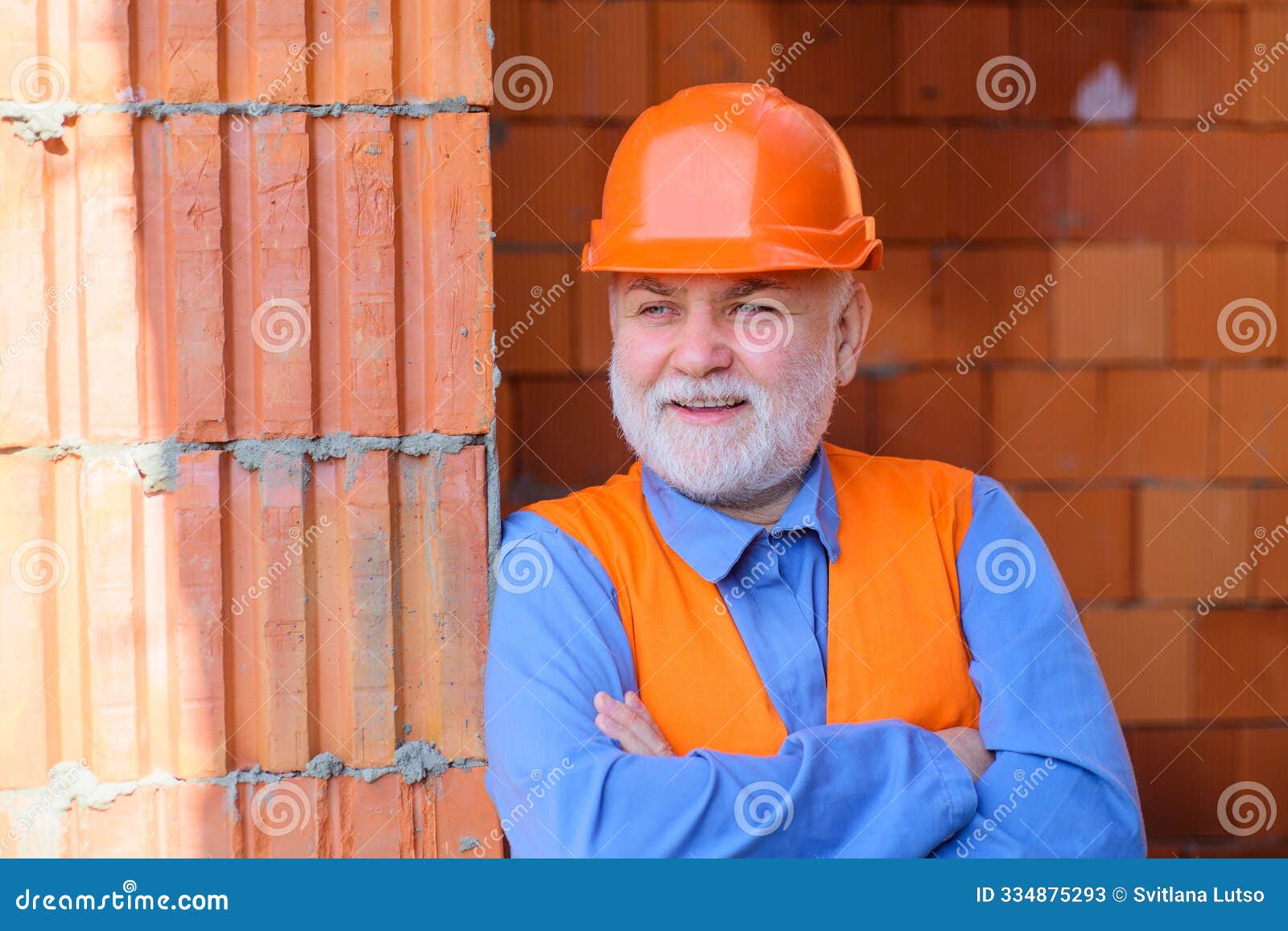 Smiling Construction Worker in Safety Vest and Helmet. Bearded Architect, Engineer or Builder in ...