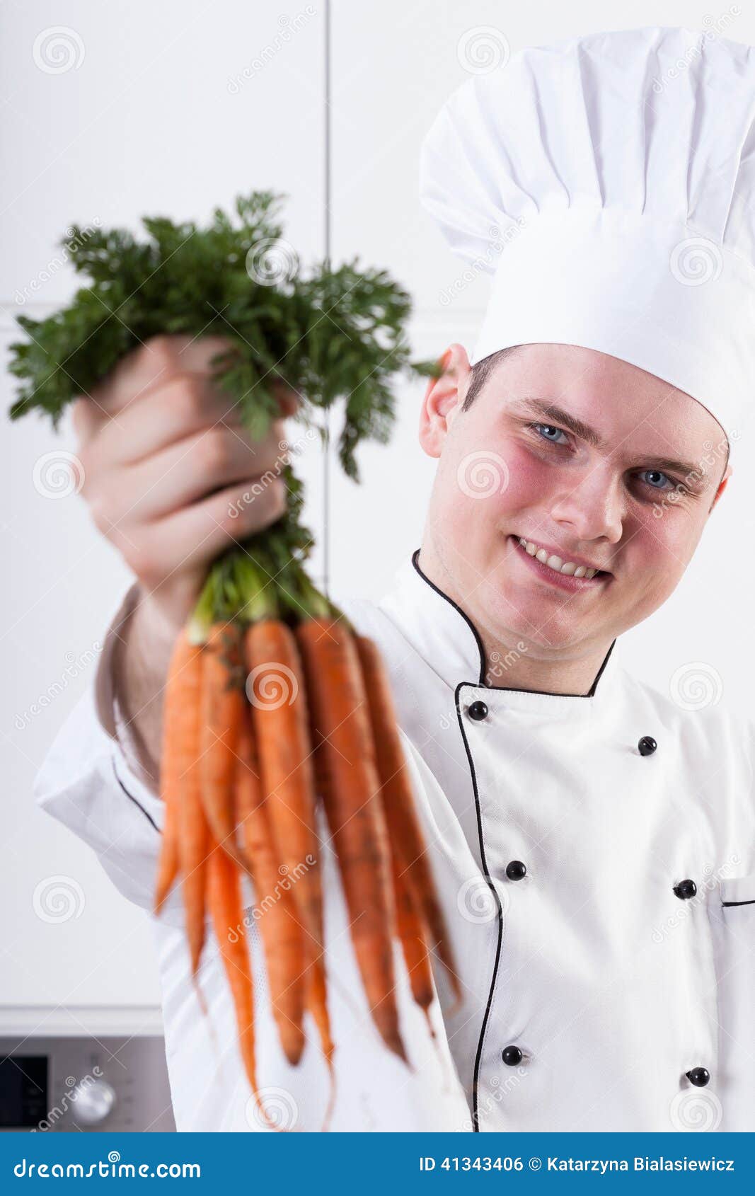 Smiling cook with carrots stock photo. Image of chef - 41343406
