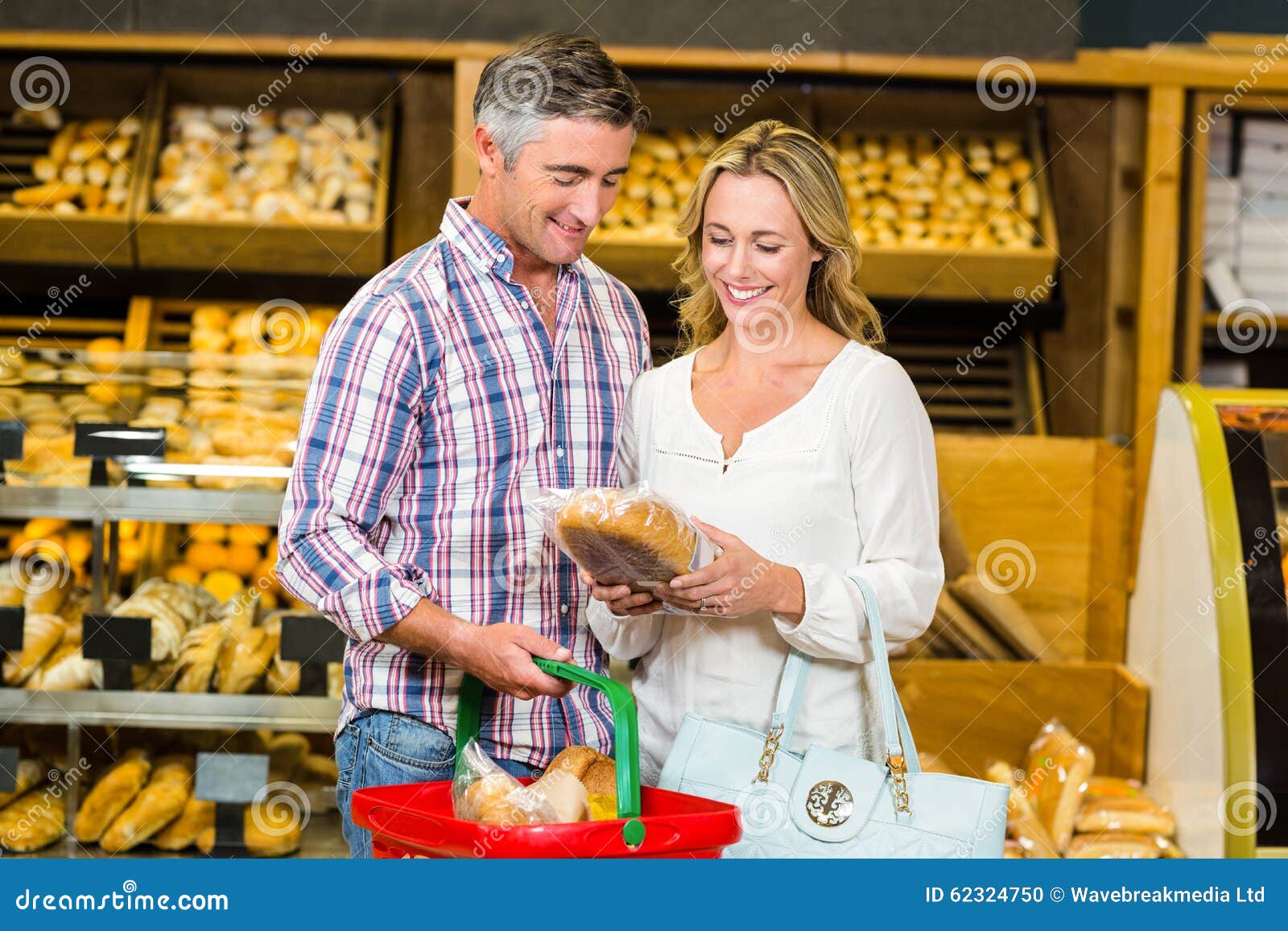Smiling Couple Buying Bread Stock Photo - Image of customer, male: 62324750