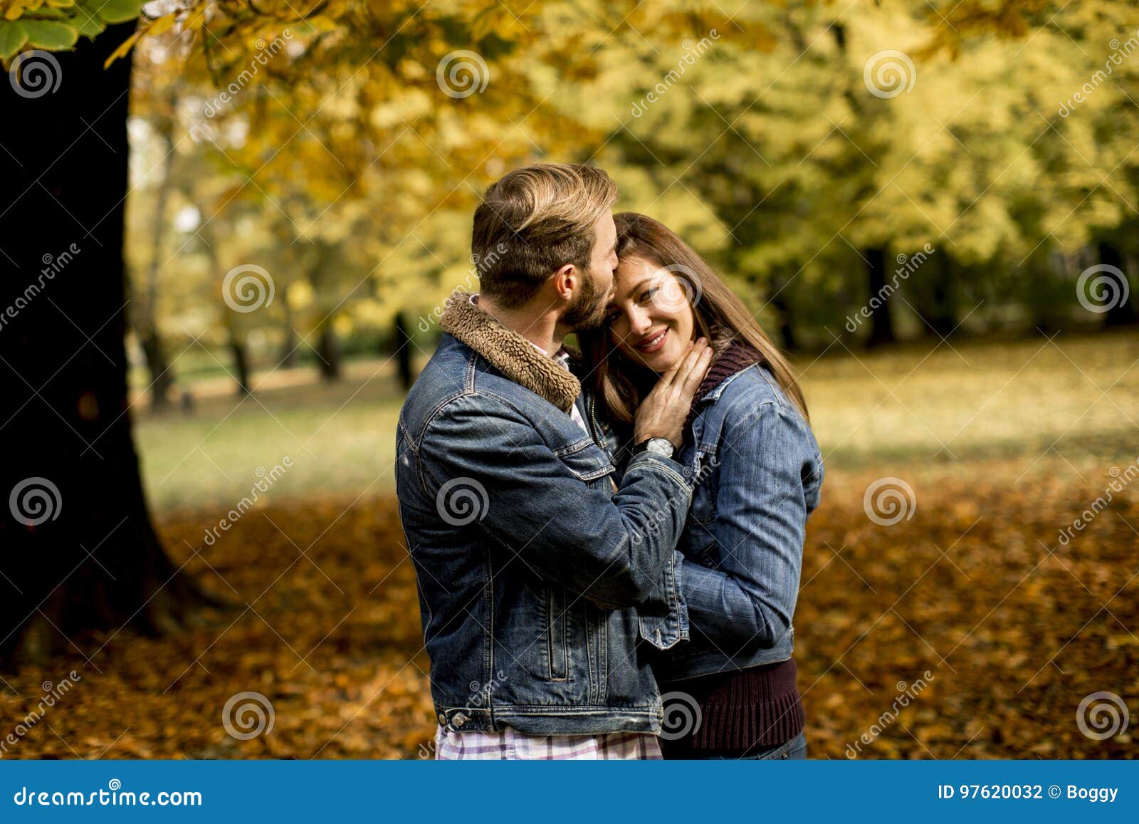 Smiling Couple Hugging in Autumn Park and Having Fun Stock Photo ...