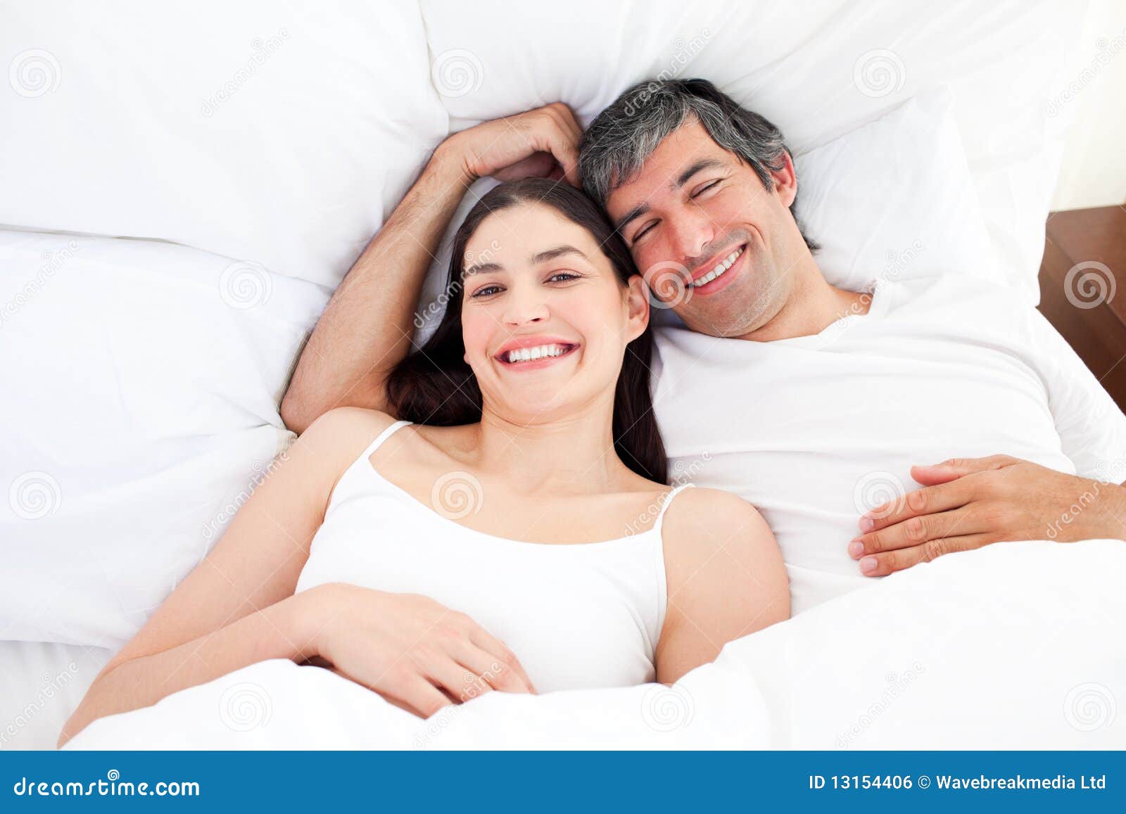 Smiling Couple Hugging Lying in Their Bed Stock Photo - Image of ...