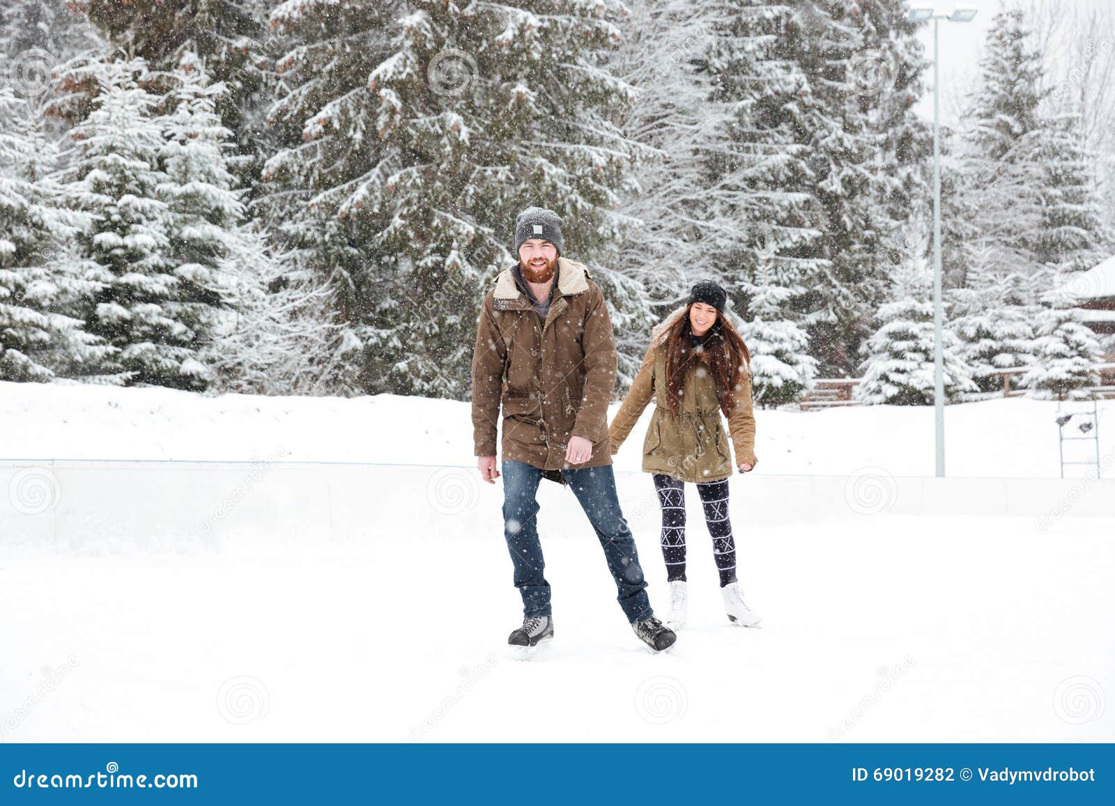 Smiling Couple Ice Skating Outdoors Stock Photo - Image of lifestyle ...