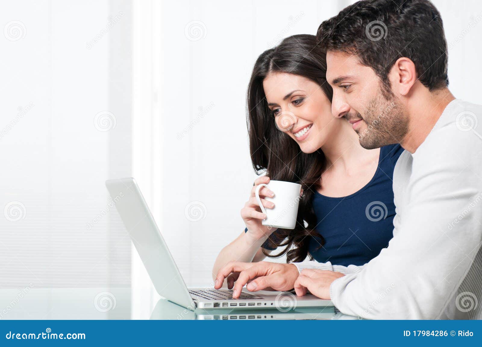 Smiling couple with laptop stock photo. Image of female - 17984286