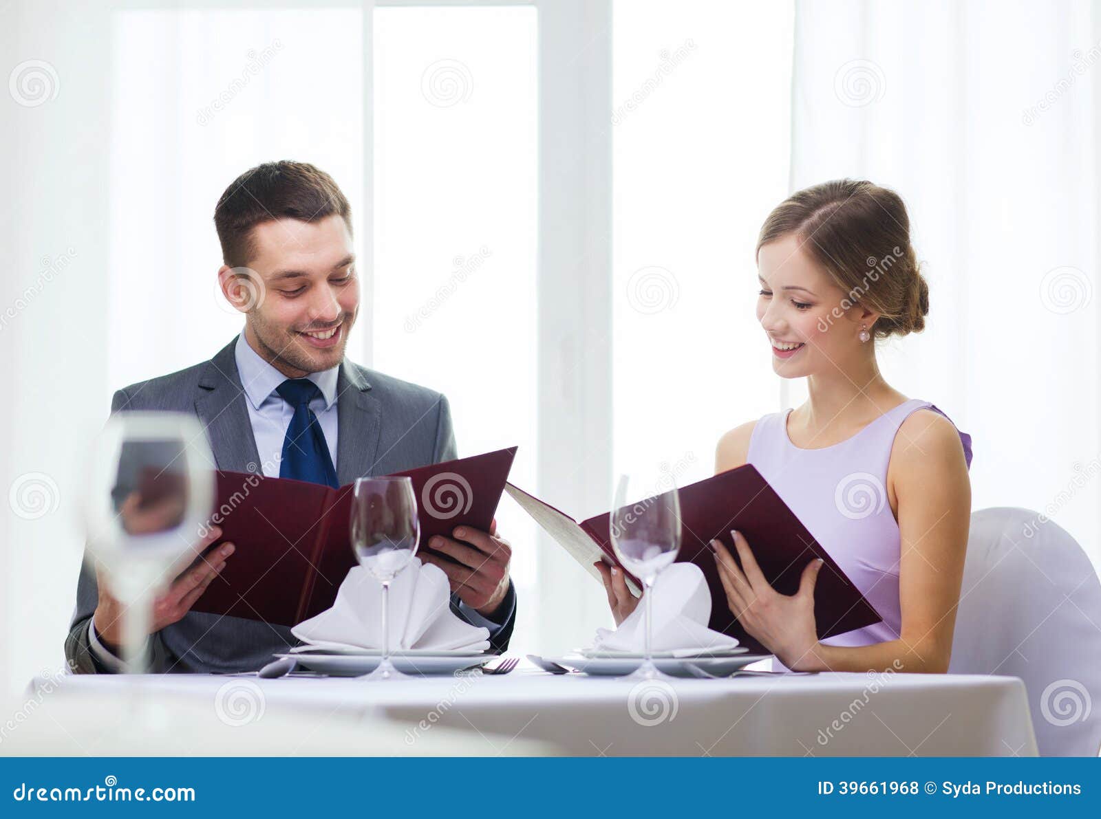 Smiling Couple with Menus at Restaurant Stock Photo - Image of happy ...