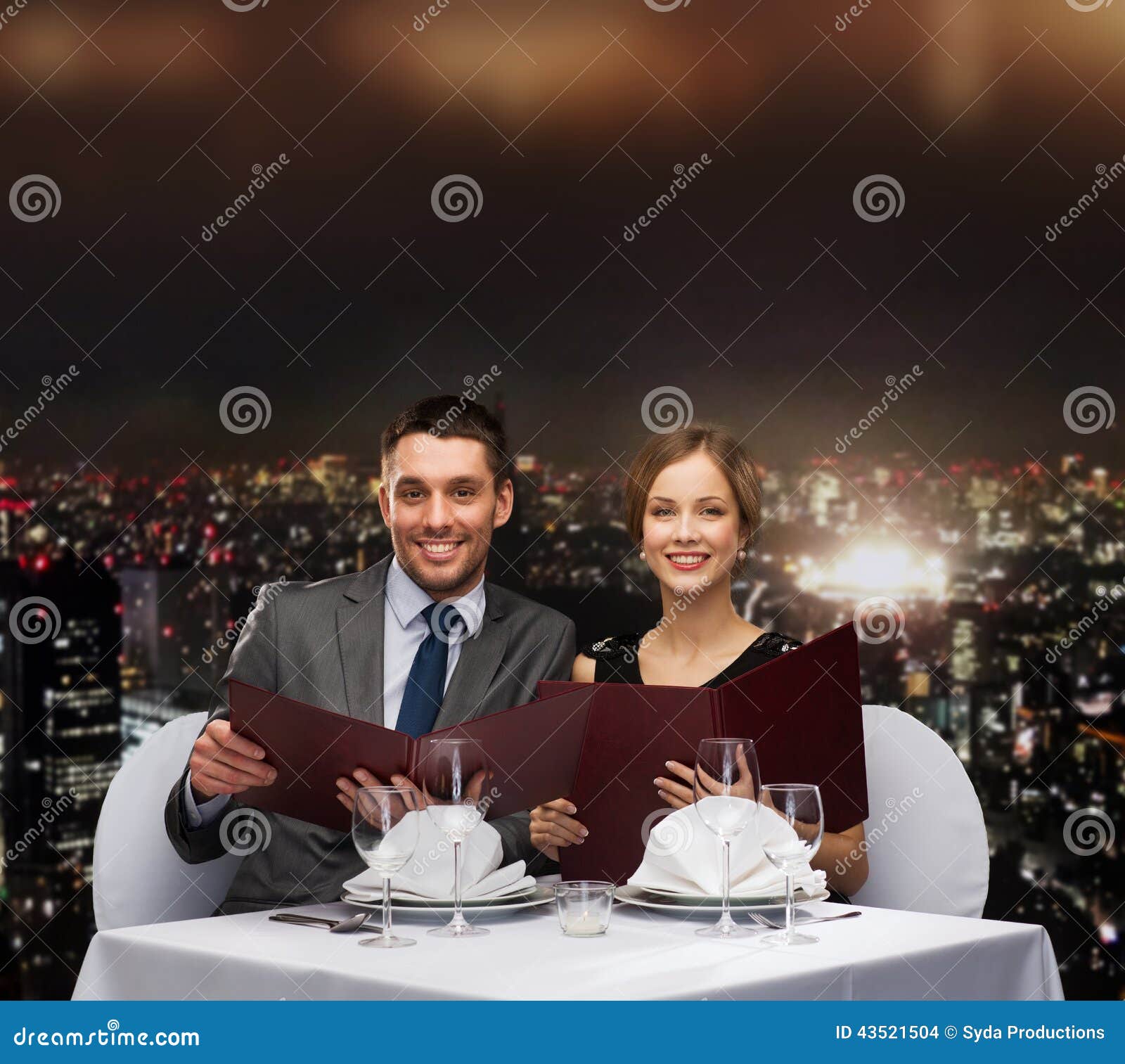 Smiling Couple with Menus at Restaurant Stock Photo - Image of dinner ...