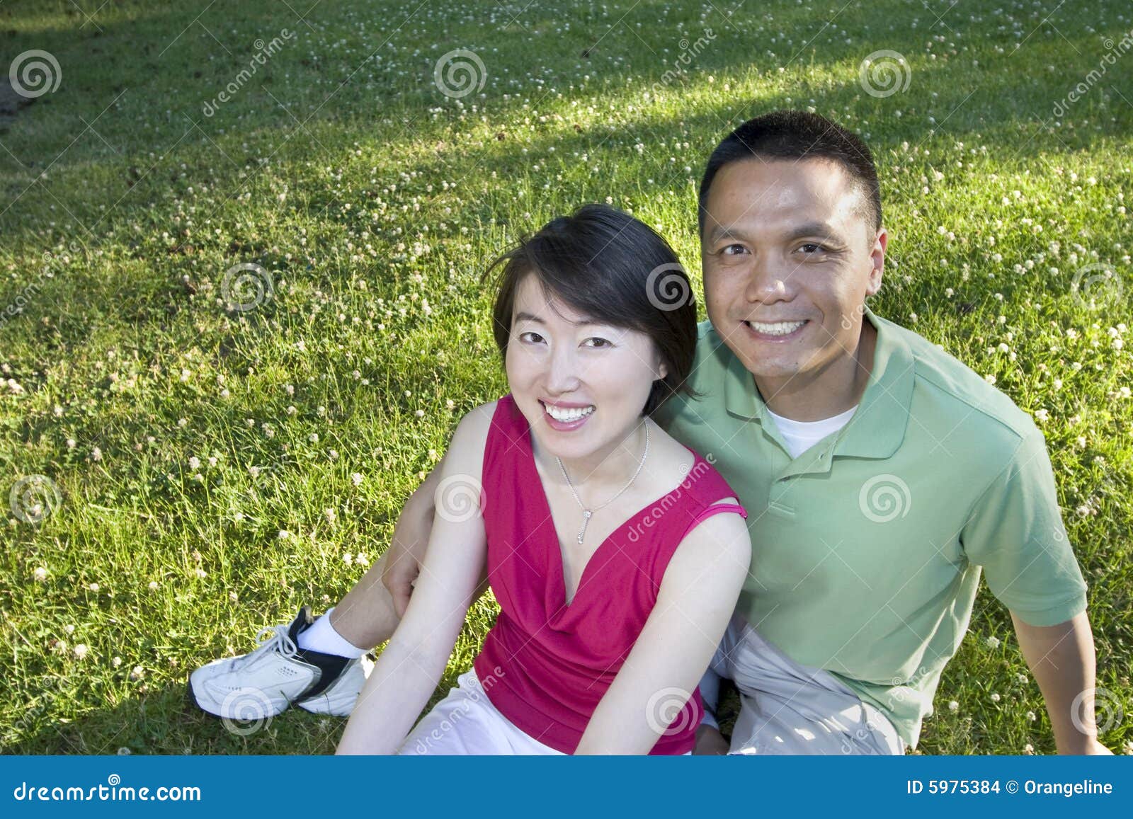 Smiling Couple Sitting on Grass - Horizontal Stock Photo - Image of ...