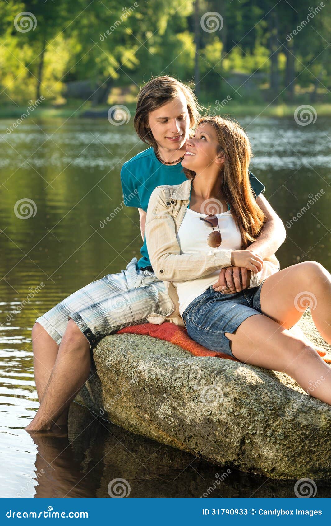 Smiling Couple Sitting on a Rock Romantic Stock Image - Image of ...