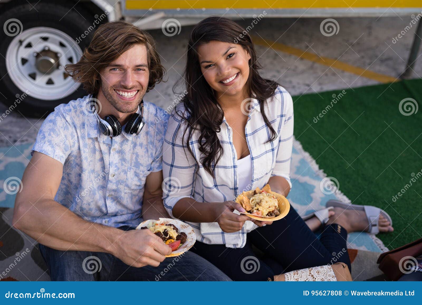 Smiling Couple Sitting with Snacks Stock Photo - Image of female ...