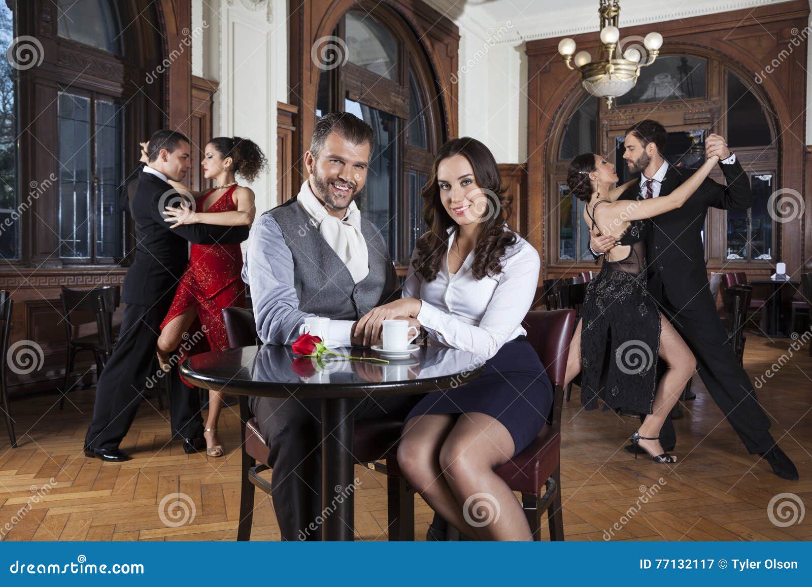 Smiling Couple Sitting at Table while Dancers Performing Tango Stock ...