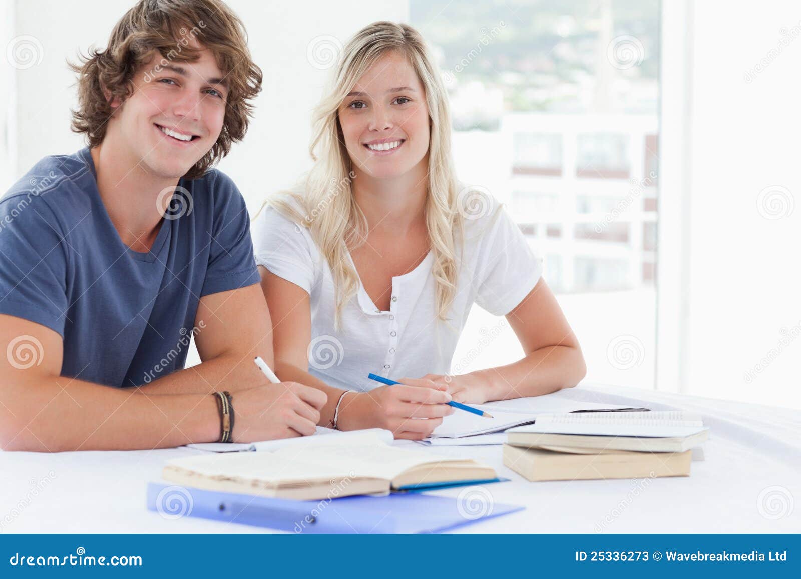 Smiling Couple of Students Looking at the Camera Stock Image - Image of ...