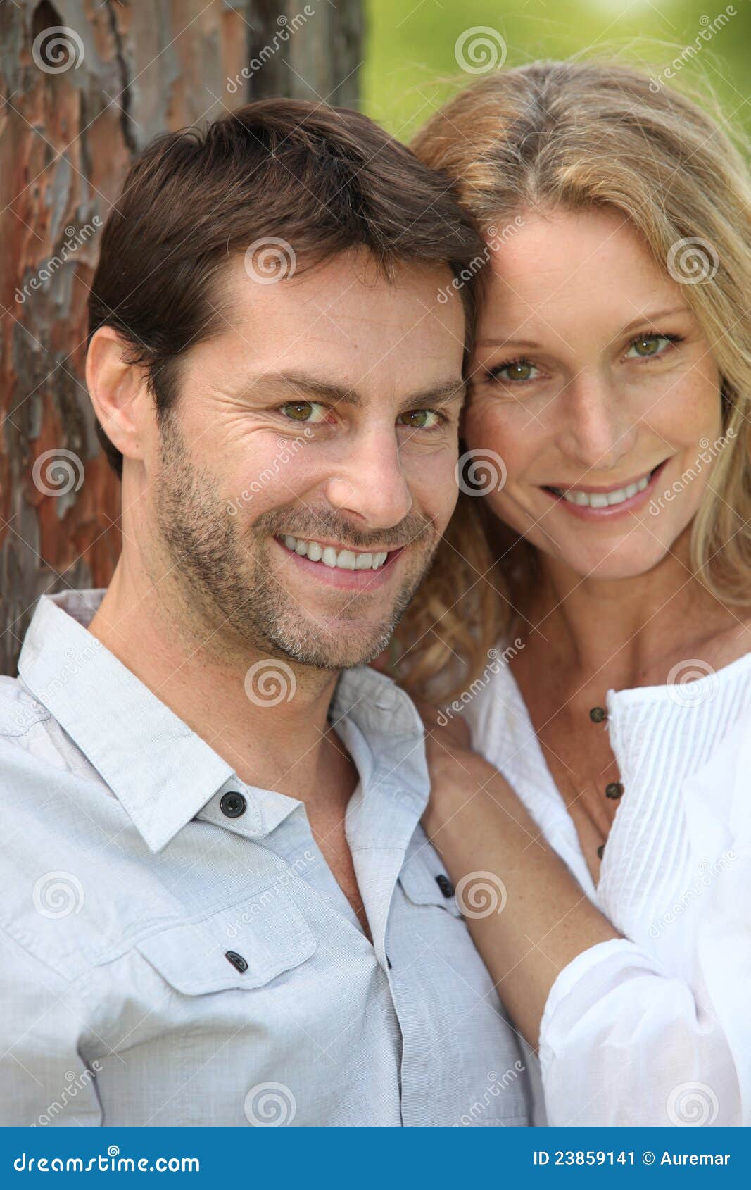 Smiling couple by tree stock image. Image of people, outside - 23859141