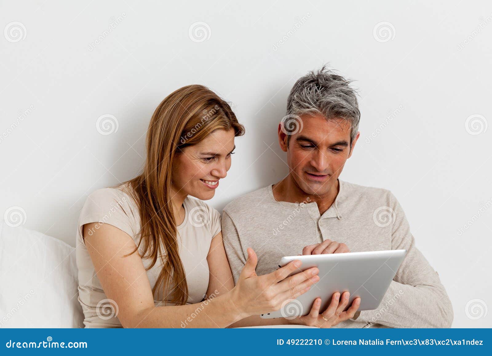 Smiling Couple Using the Ipad Stock Photo - Image of sitting, tablet ...