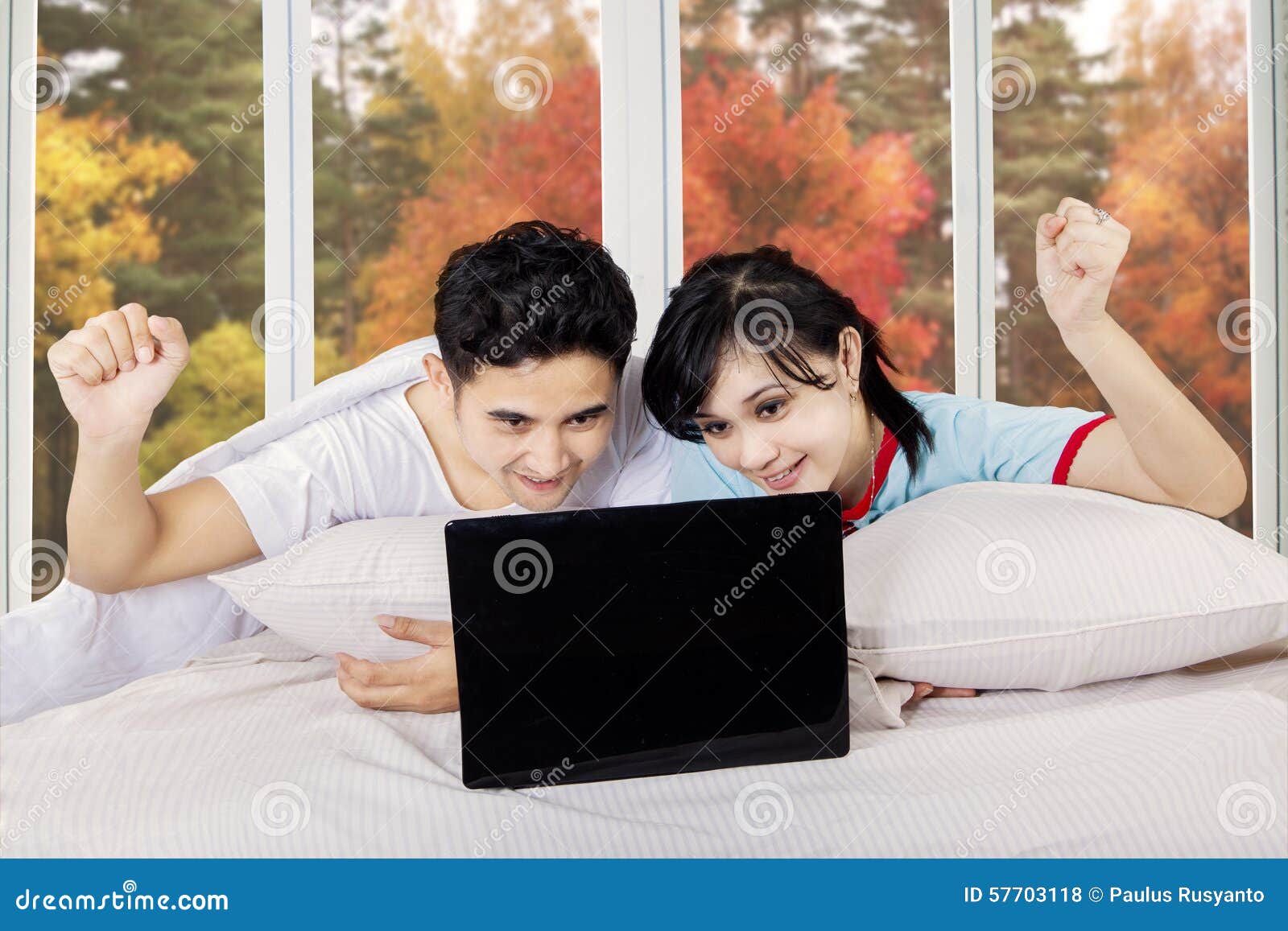 Smiling Couple Using Laptop on Bedroom Stock Photo - Image of internet ...
