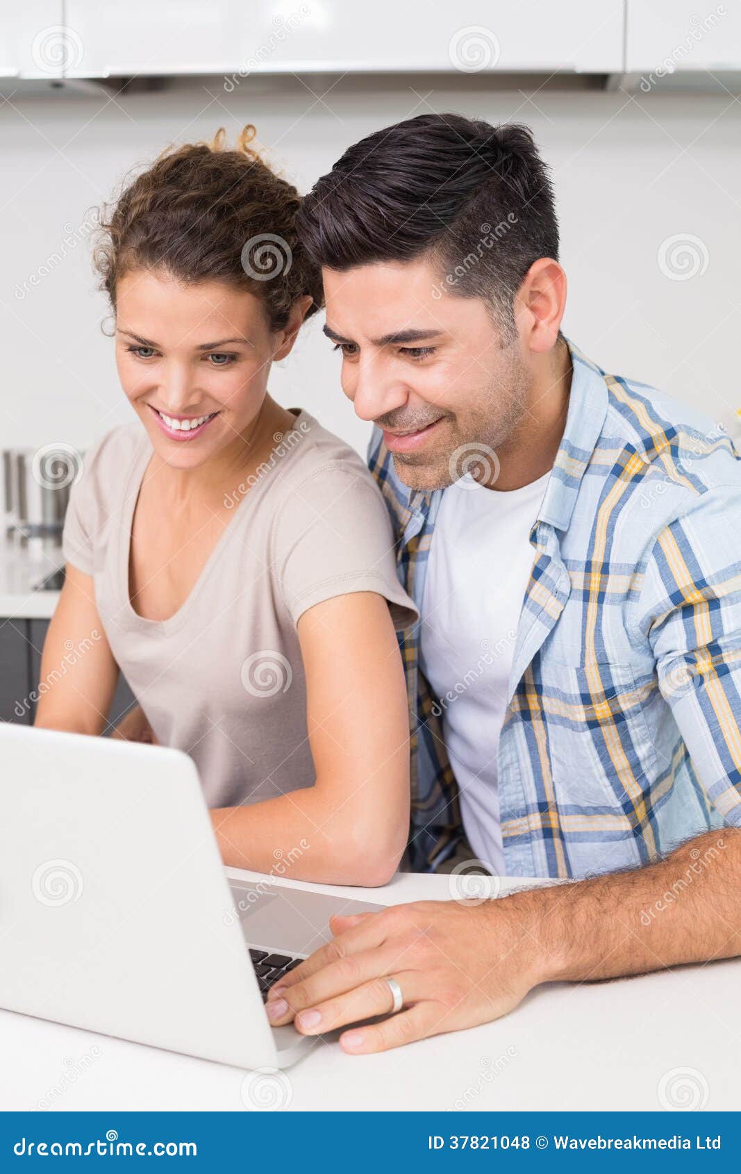Smiling Couple Using Laptop Together Stock Photo - Image of apartment ...