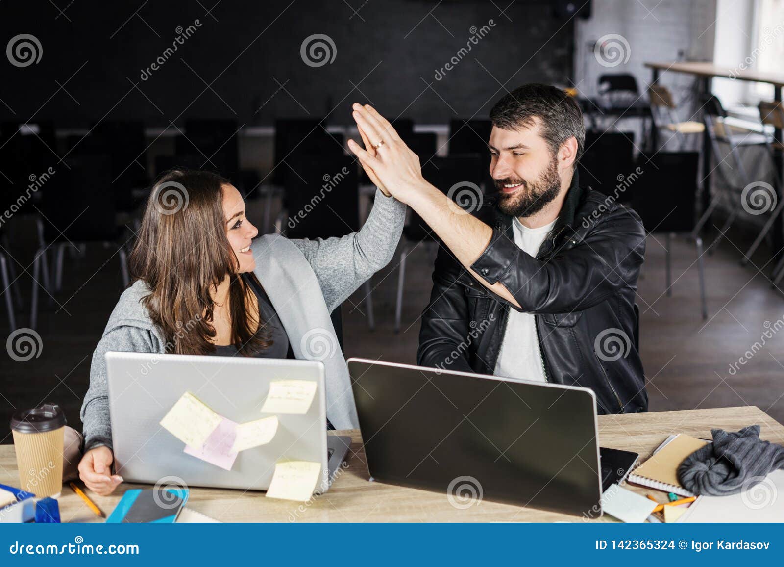 Smiling Couple Using Laptops and Giving High Five Stock Photo - Image ...