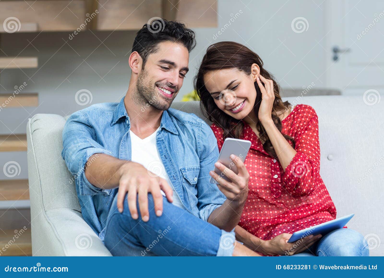Smiling couple using phone stock image. Image of digital - 68233281