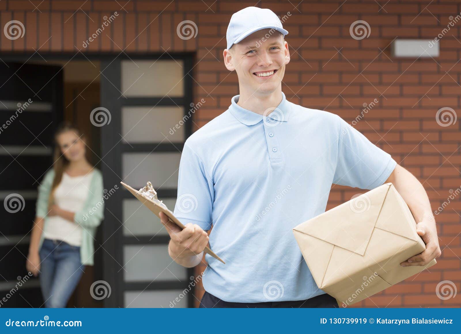 Courier in Uniform Holding Package and Delivering it To Recipient Stock ...