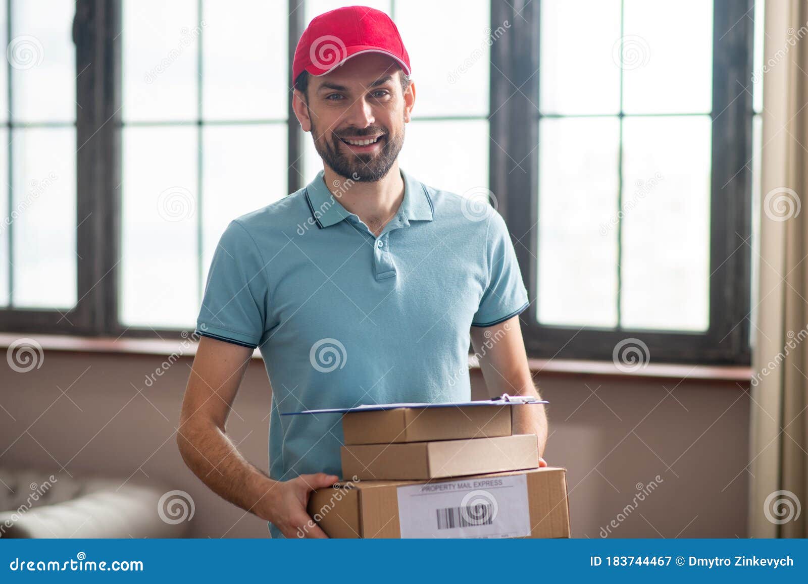 Delivery Person Standing in the Kitchen and Holding the Boxes in His ...