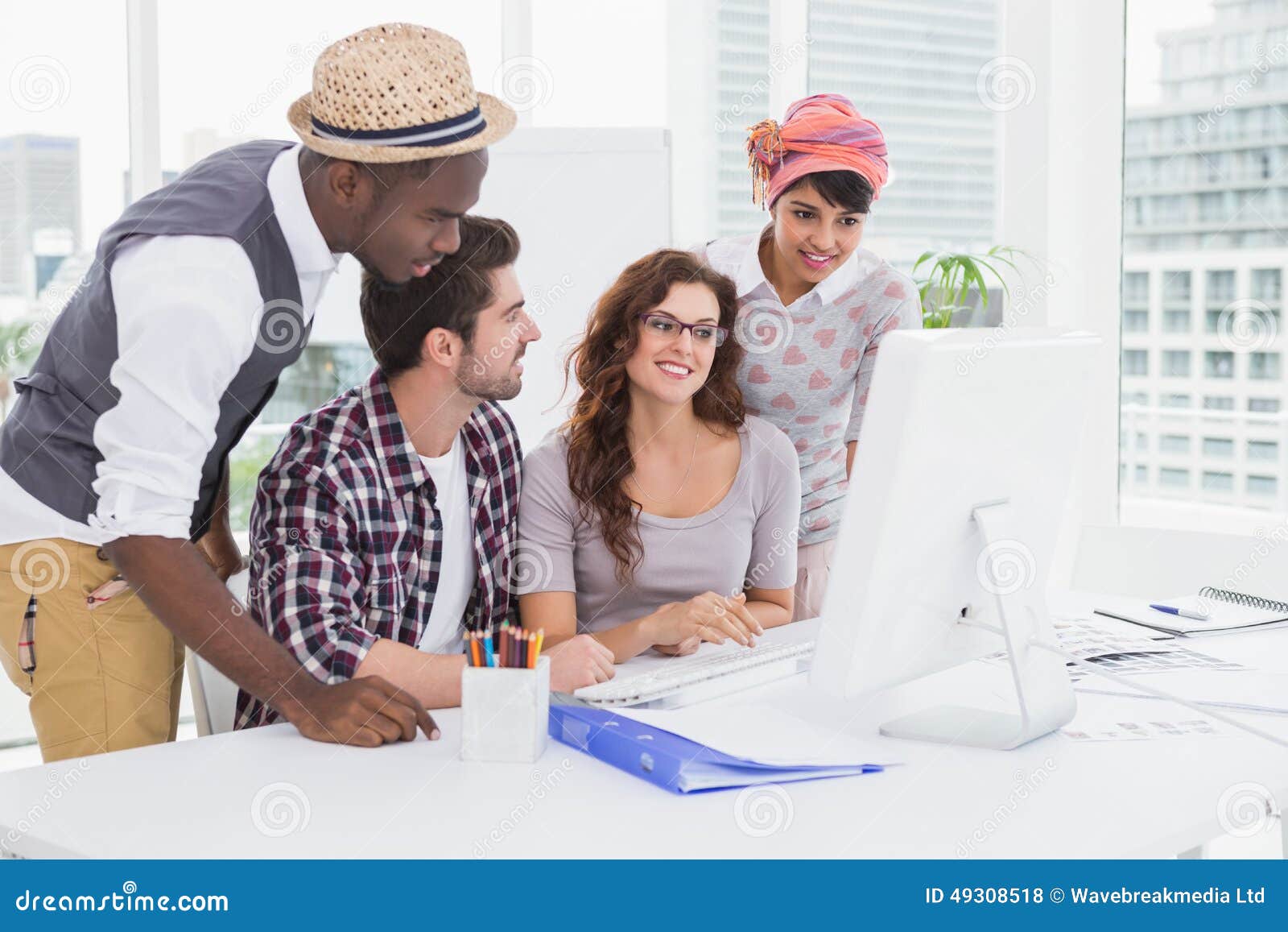 Smiling Coworkers Using Computer Monitor Stock Photo - Image of ...