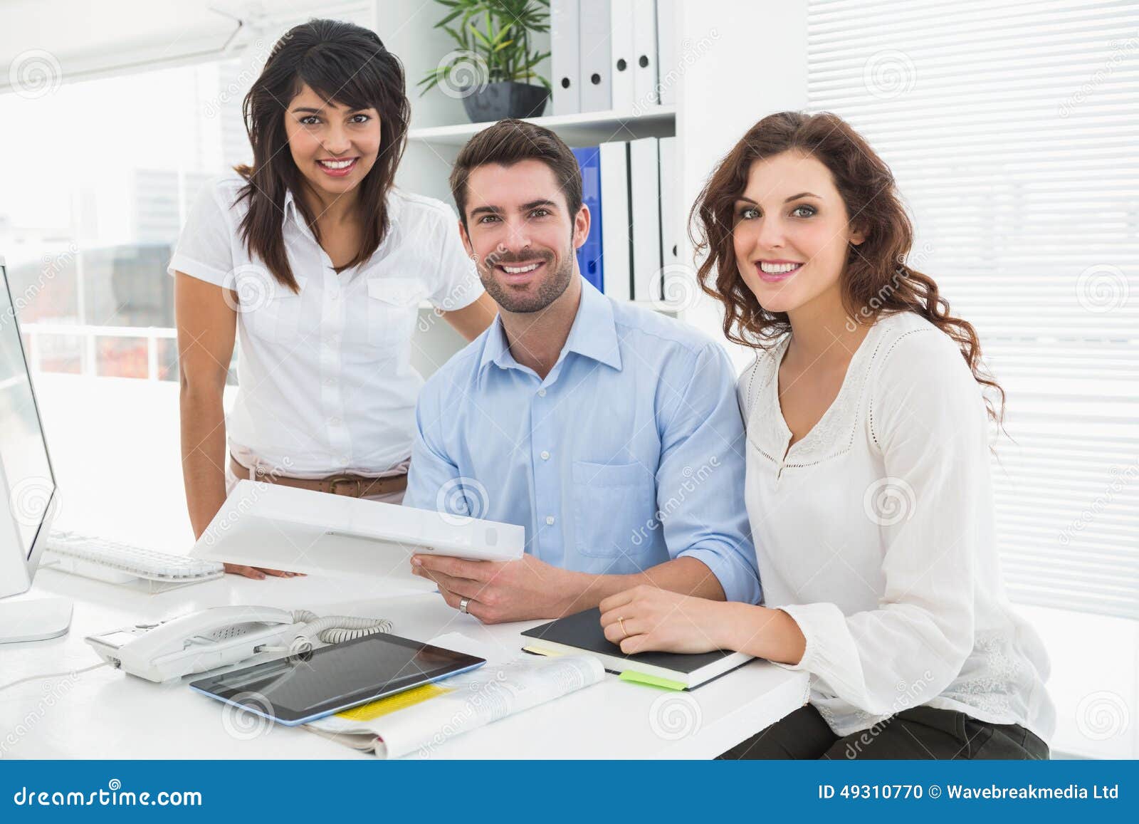 Smiling Coworkers Working Together at Desk Stock Photo - Image of ...