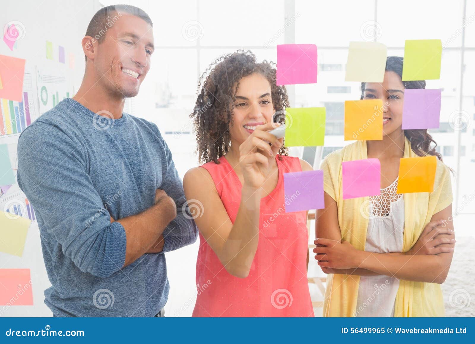 Smiling Coworkers Writing on Sticky Notes Stock Image - Image of ...