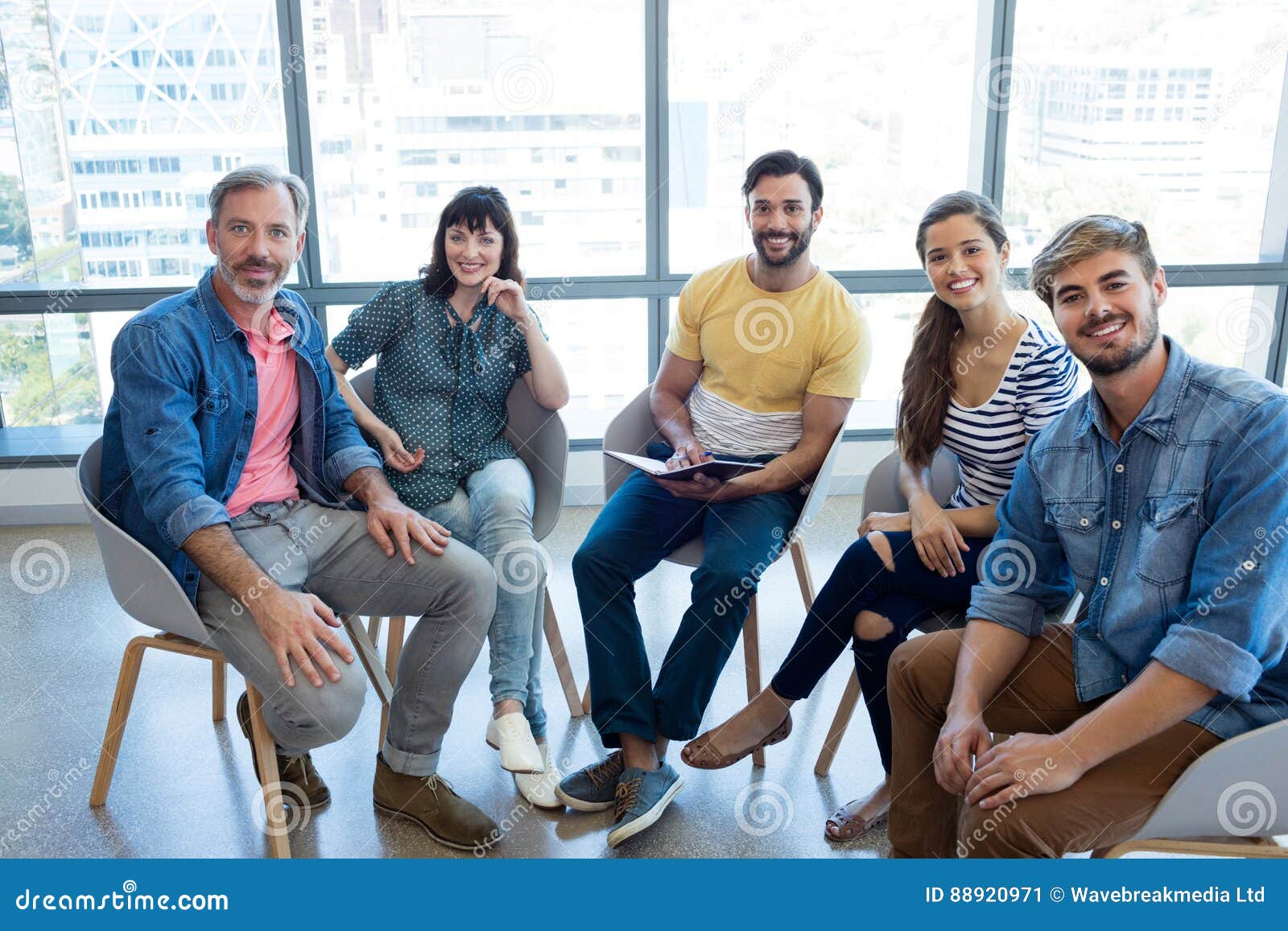 Smiling Creative Business Team Sitting Together in Office Stock Image ...