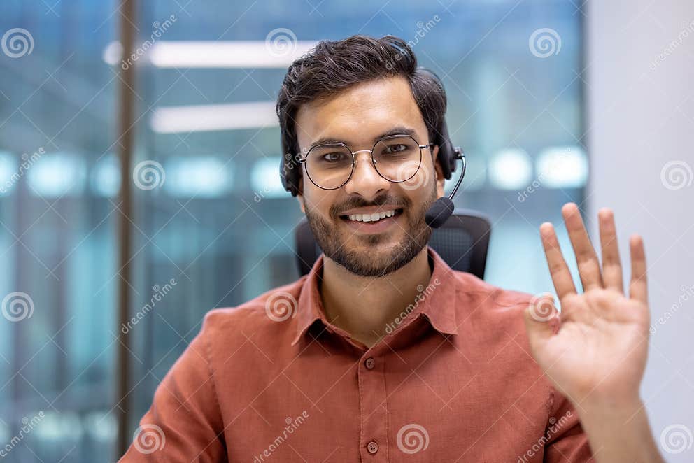 Smiling Customer Service Representative with Headset Waving Hand during ...