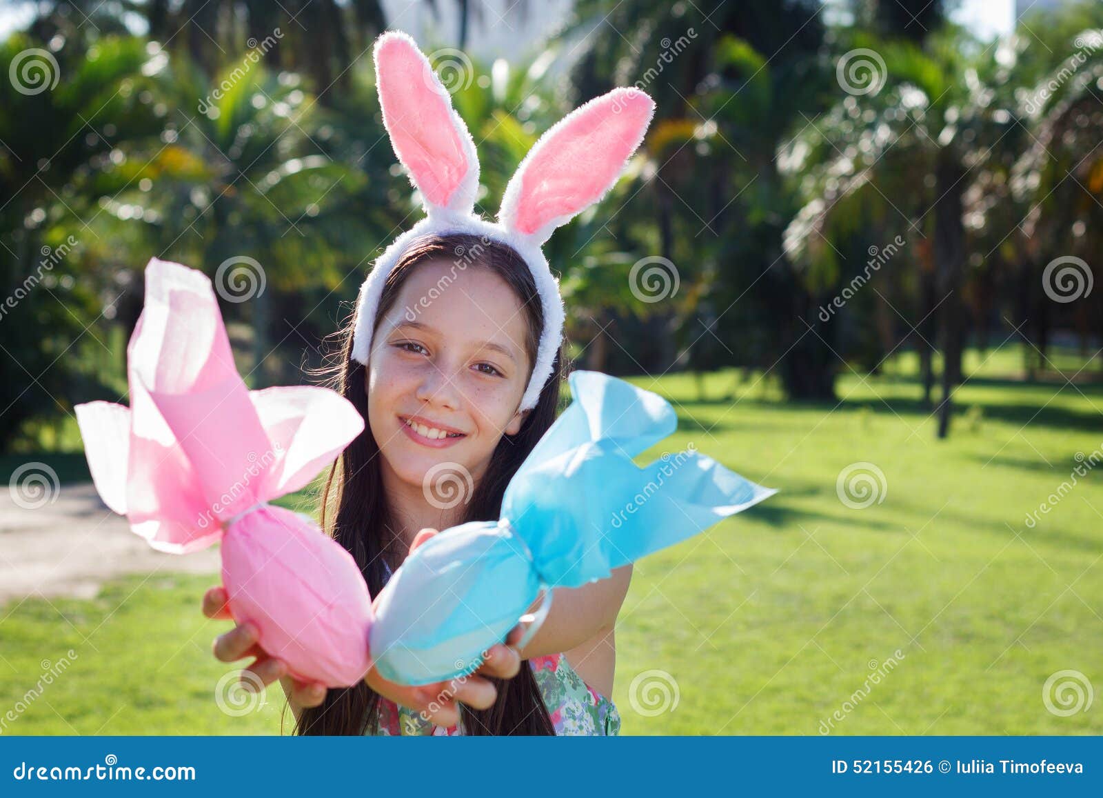 Smiling Cute Teen Girl With Rabbit Ears Holding Easter Chocolate Stock