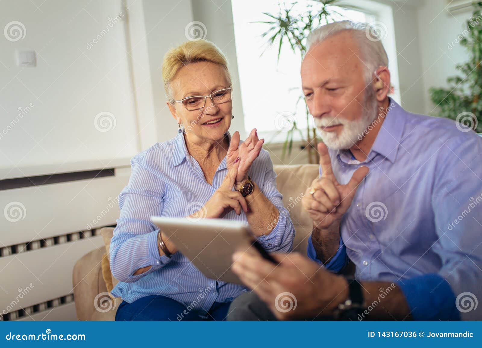 Deaf Senior Couple Talking Using Sign Language on the Digital Tablet`s ...