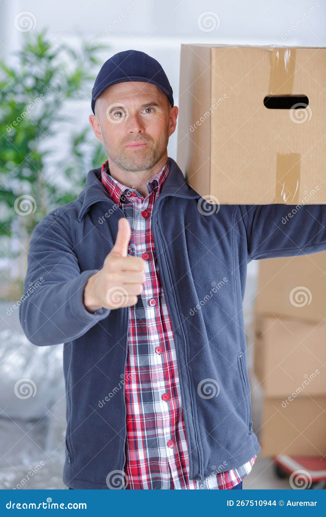 Smiling Delivery Man with Box Showing Thumb Up Stock Photo - Image of ...