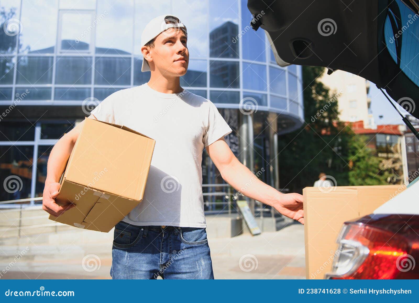 Smiling Delivery Man Holding a Paper Box Stock Photo - Image of express ...