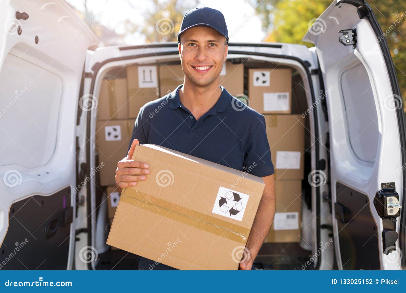 Smiling Delivery Man Loading Boxes Into His Truck Stock Photo - Image ...
