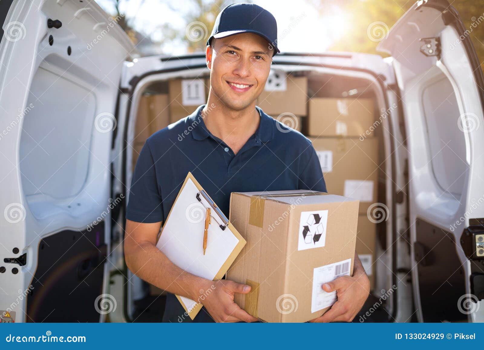 Smiling Delivery Man Loading Boxes into His Truck Stock Image - Image ...