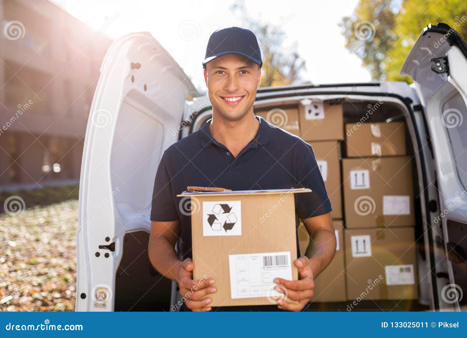 Smiling Delivery Man Loading Boxes into His Truck Stock Image - Image ...