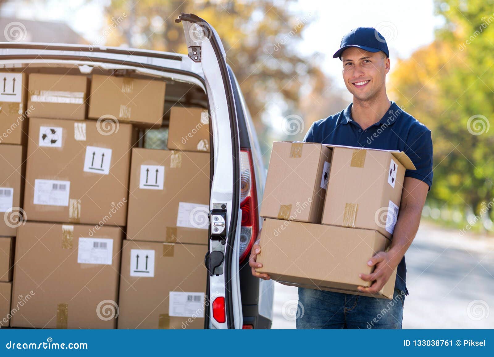 Smiling Delivery Man Loading Boxes Into His Truck Royalty-Free Stock ...