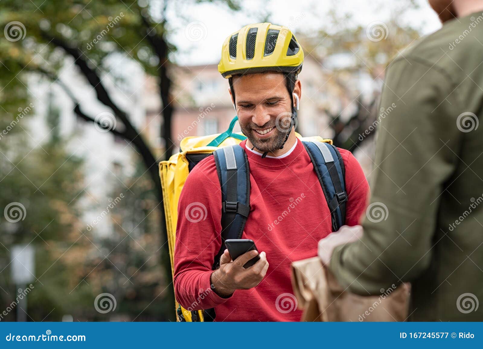 Delivery Man Checking Food Order with Smartphone Stock Image - Image of ...