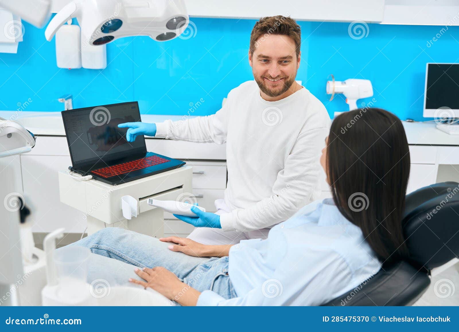 Smiling Dentist Showing Image of Client Teeth on Digital Display Stock ...