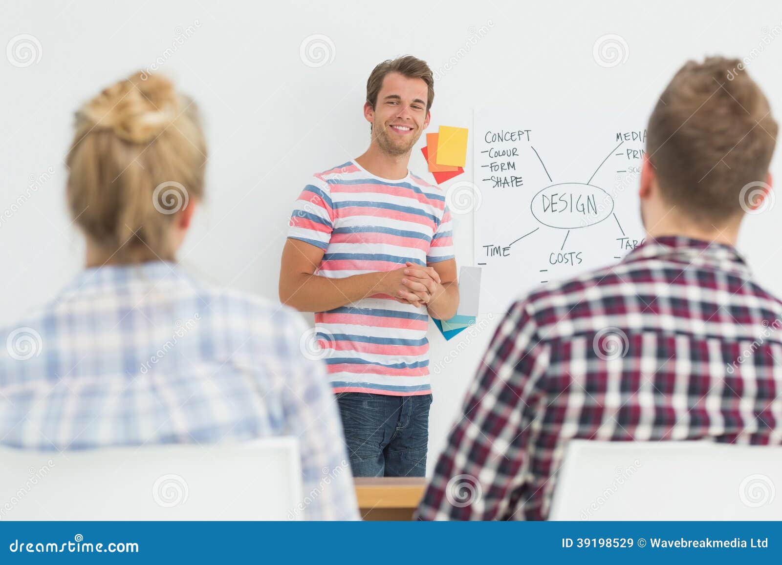 Smiling Designer Presenting Ideas To Colleagues Stock Image - Image of ...