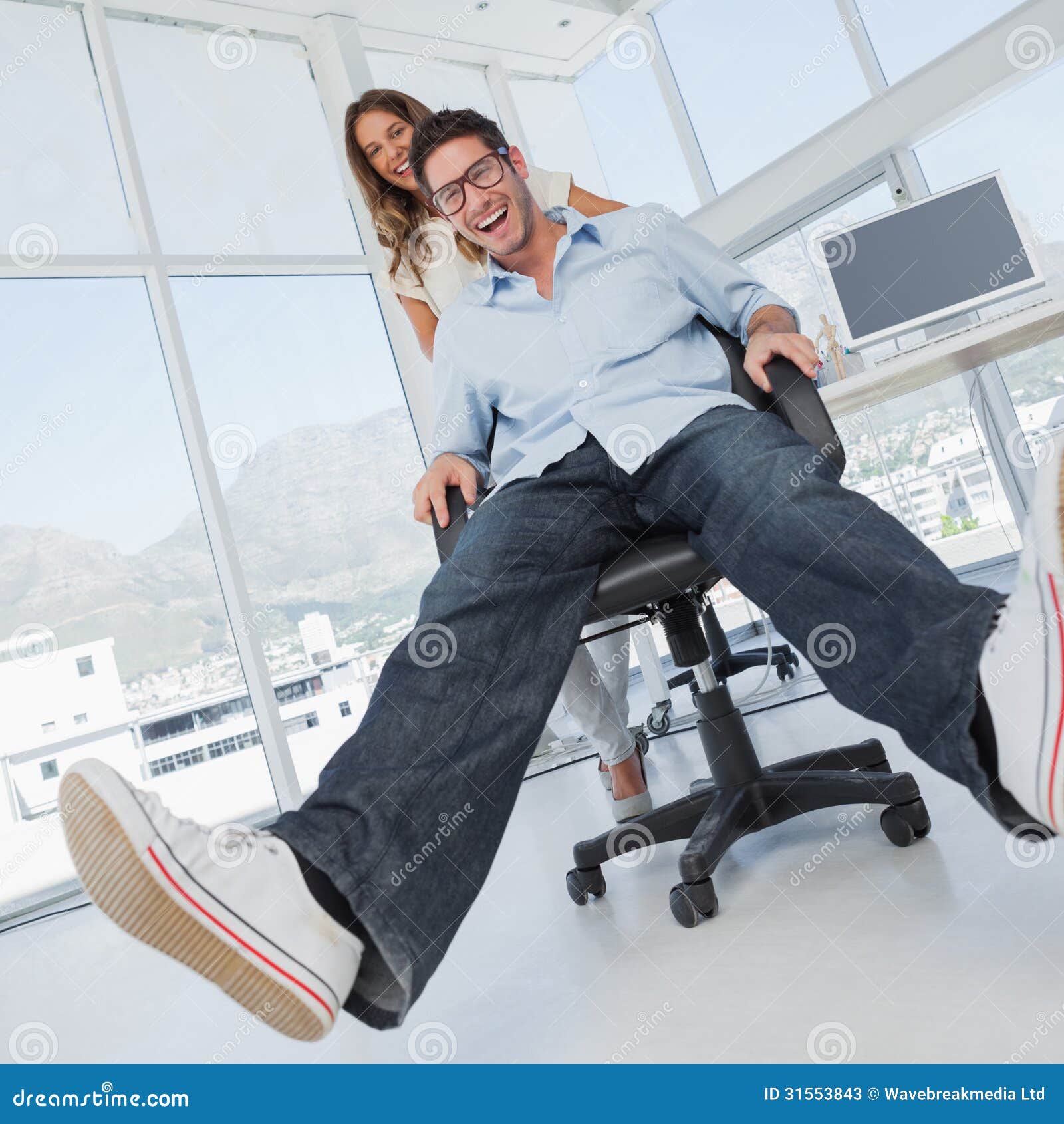 Smiling Designers Having Fun with on a Swivel Chair Stock Image - Image ...